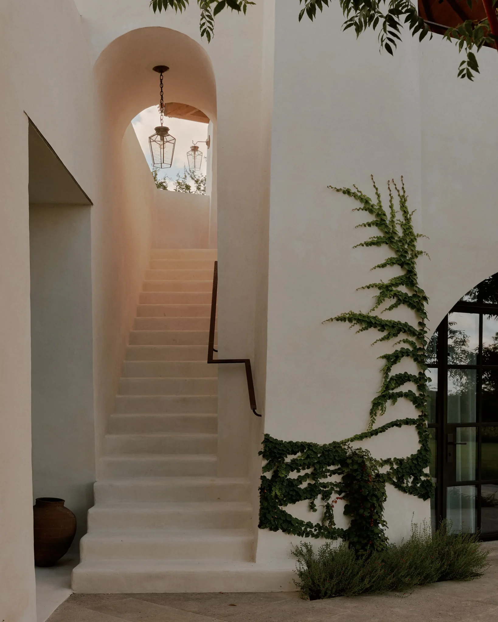 arches and rustic details define a modern mediterranean home in austin ...