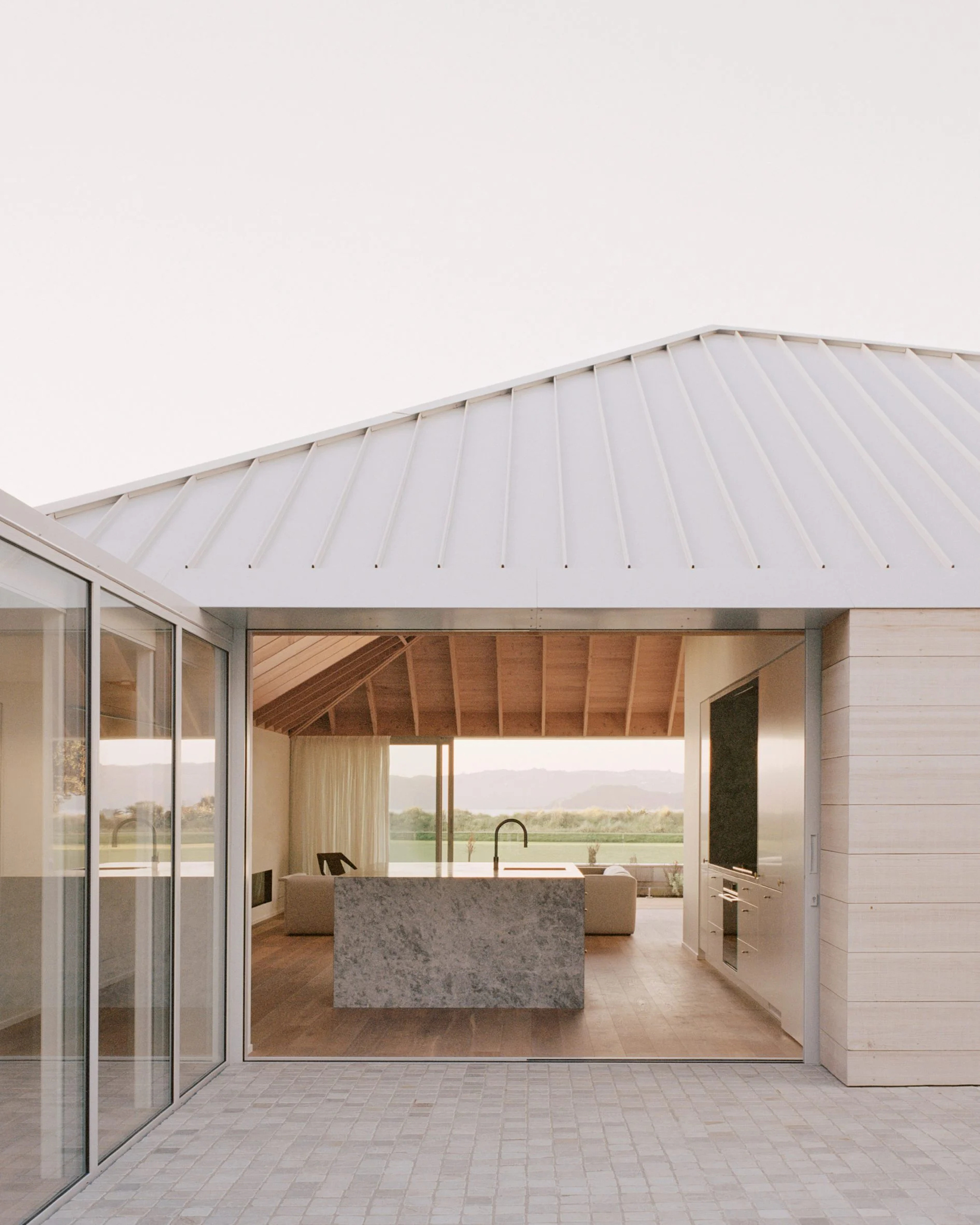 wood and verdant nature envelopes wellington's rk residence in timeless ...