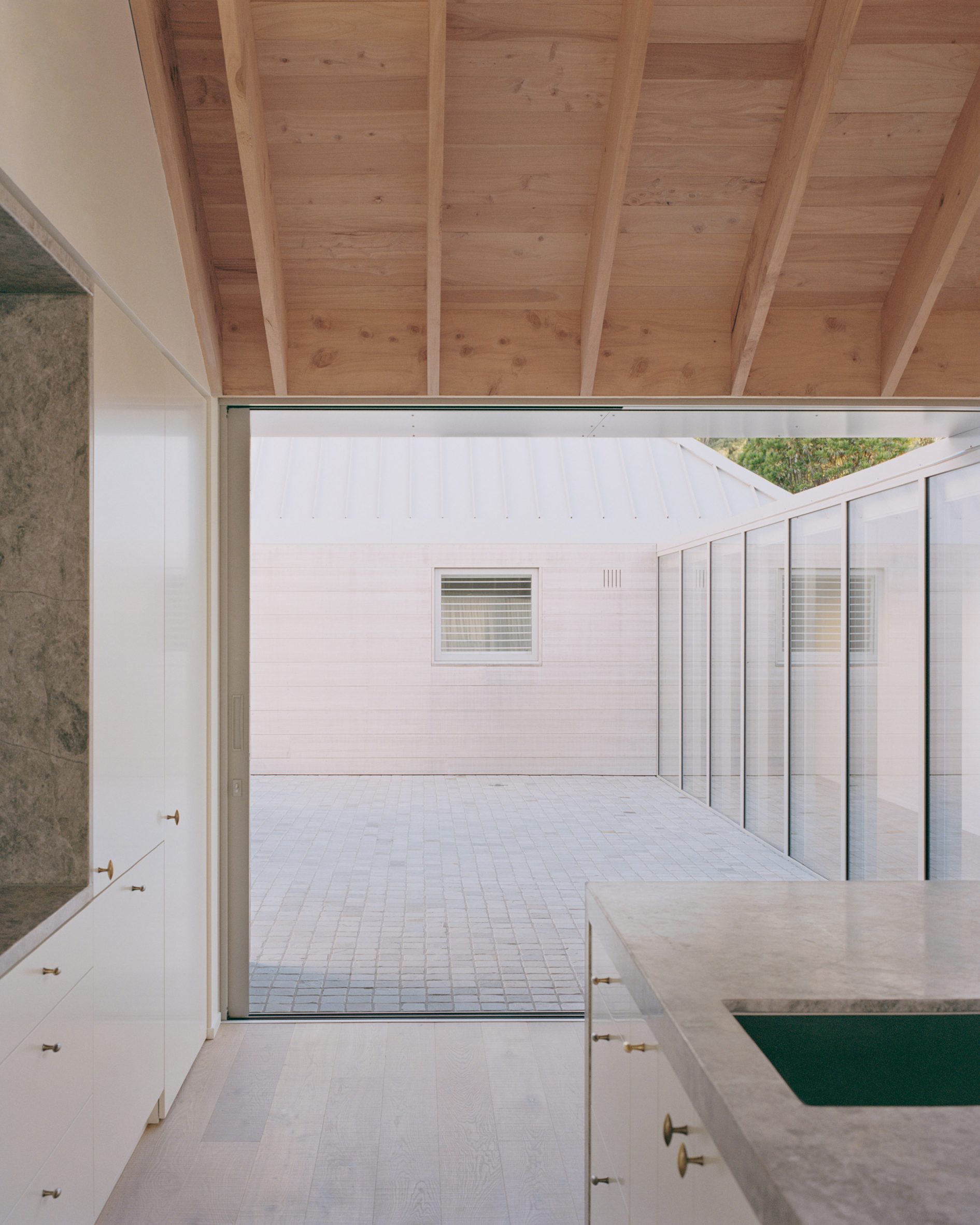 wood and verdant nature envelopes wellington's rk residence in timeless ...