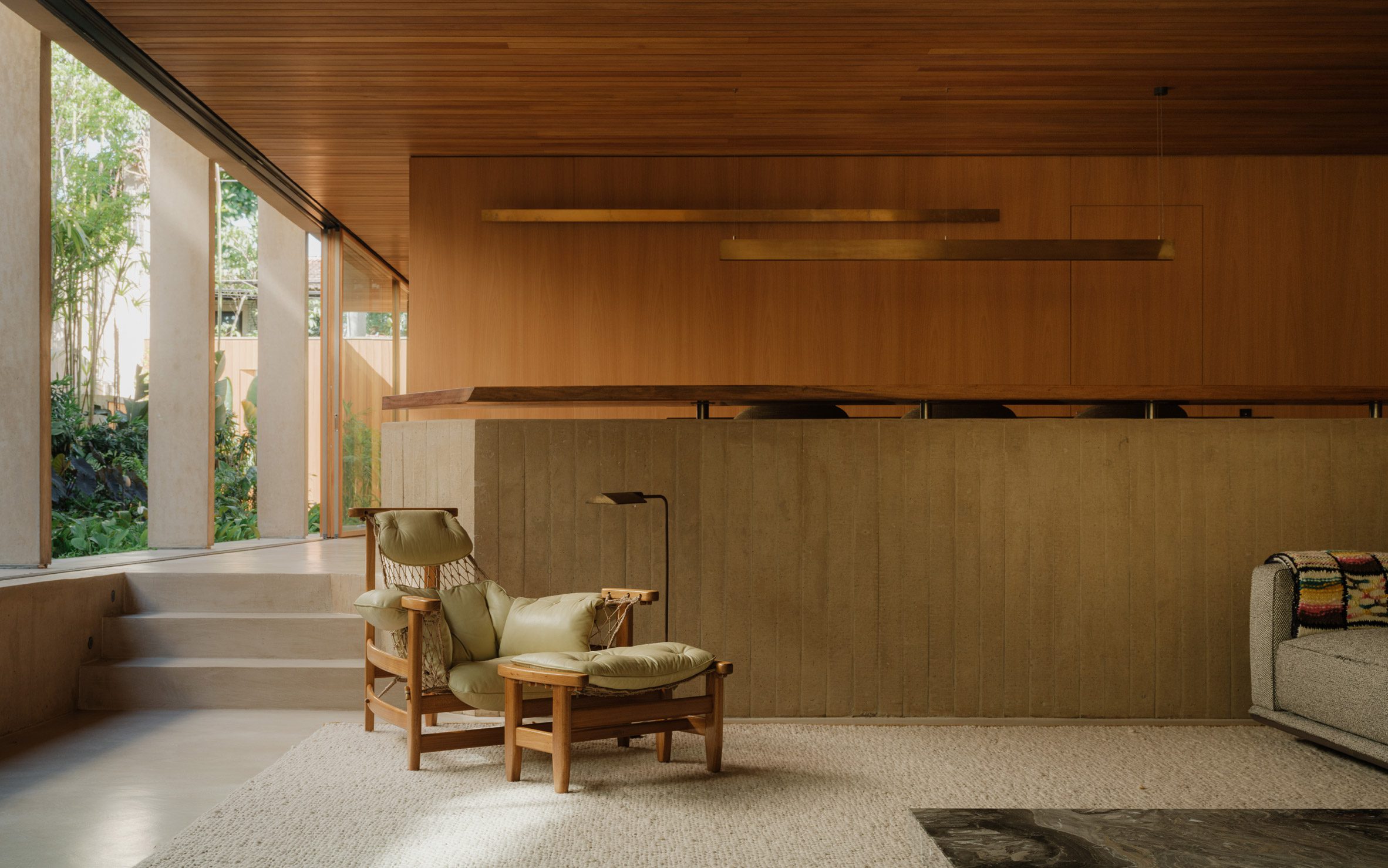 raw concrete and muted tones anchor open-plan interiors at rua polônia ...