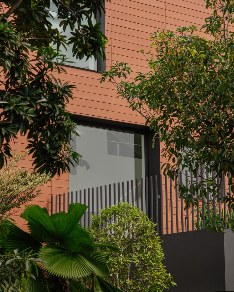 in between house is a courtyard sanctuary of light, brick, and trees ...