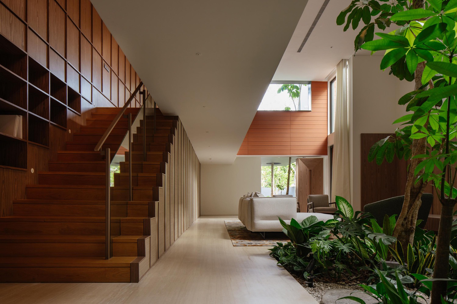 in between house is a courtyard sanctuary of light, brick, and trees ...