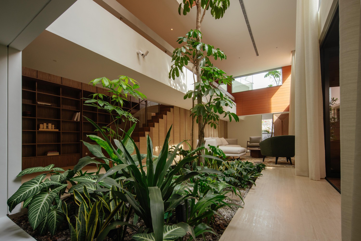 in between house is a courtyard sanctuary of light, brick, and trees ...