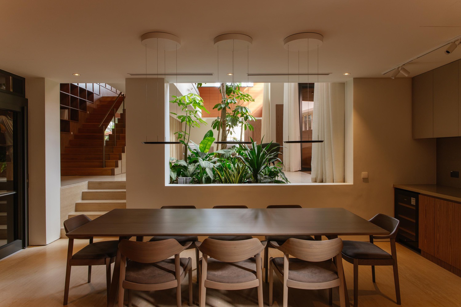 in between house is a courtyard sanctuary of light, brick, and trees ...