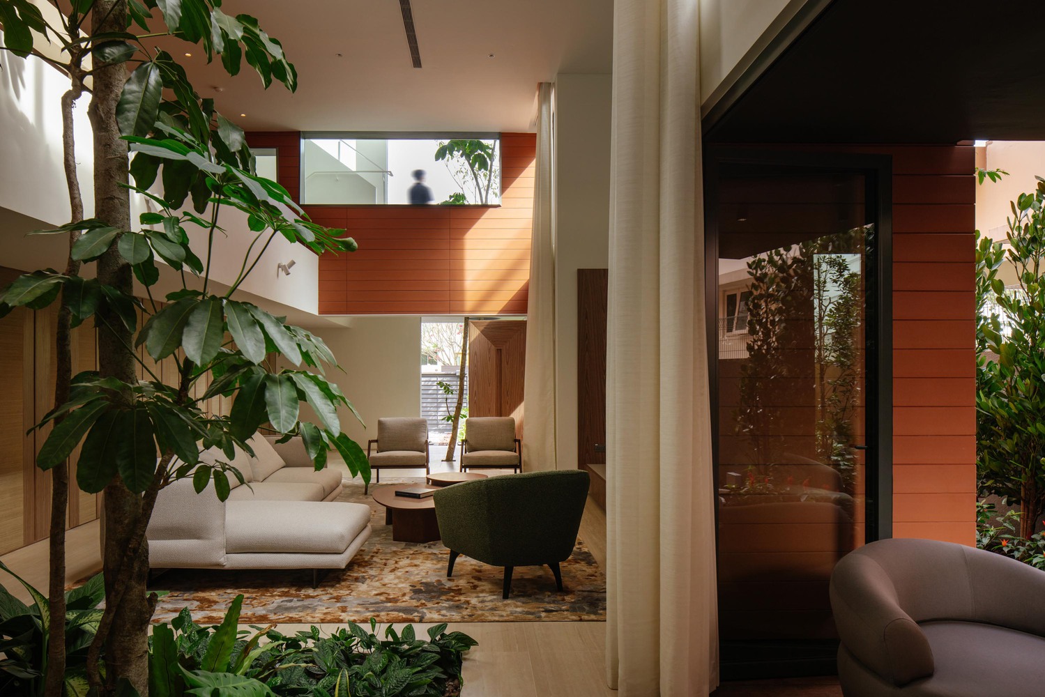 in between house is a courtyard sanctuary of light, brick, and trees ...