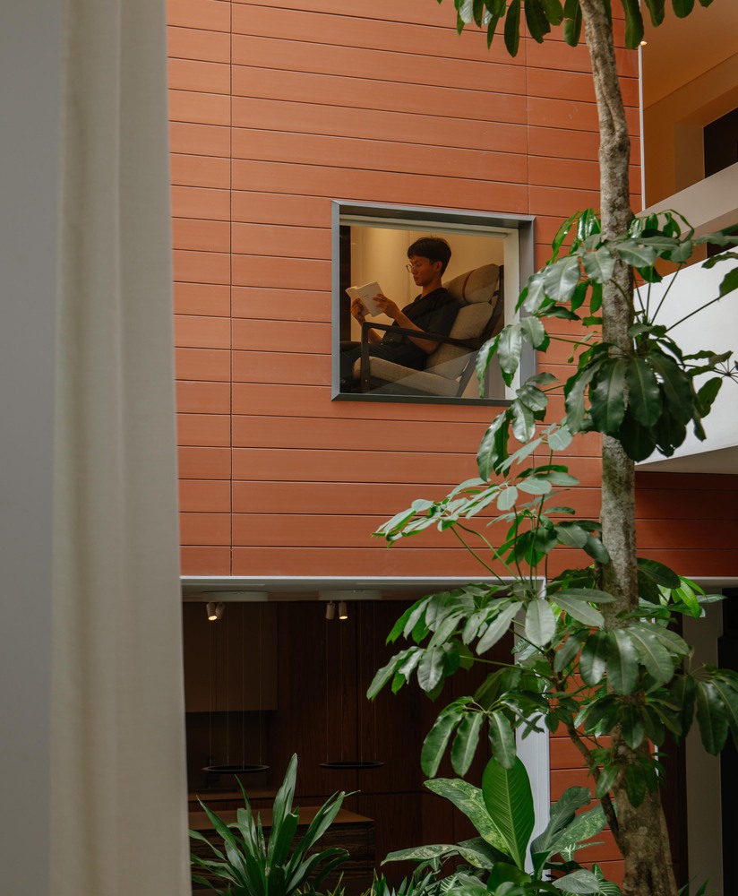 in between house is a courtyard sanctuary of light, brick, and trees ...
