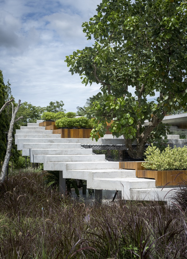 the pomelo amphawa cafe utilizes amphitheater design to capture ...