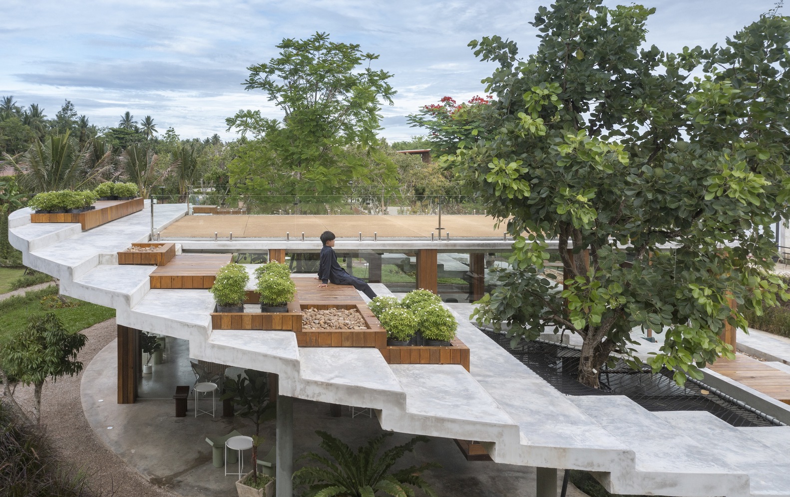 the pomelo amphawa cafe utilizes amphitheater design to capture ...